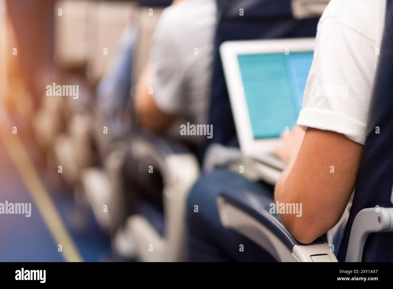 Man typing on a laptop aboard the plane Stock Photo - Alamy