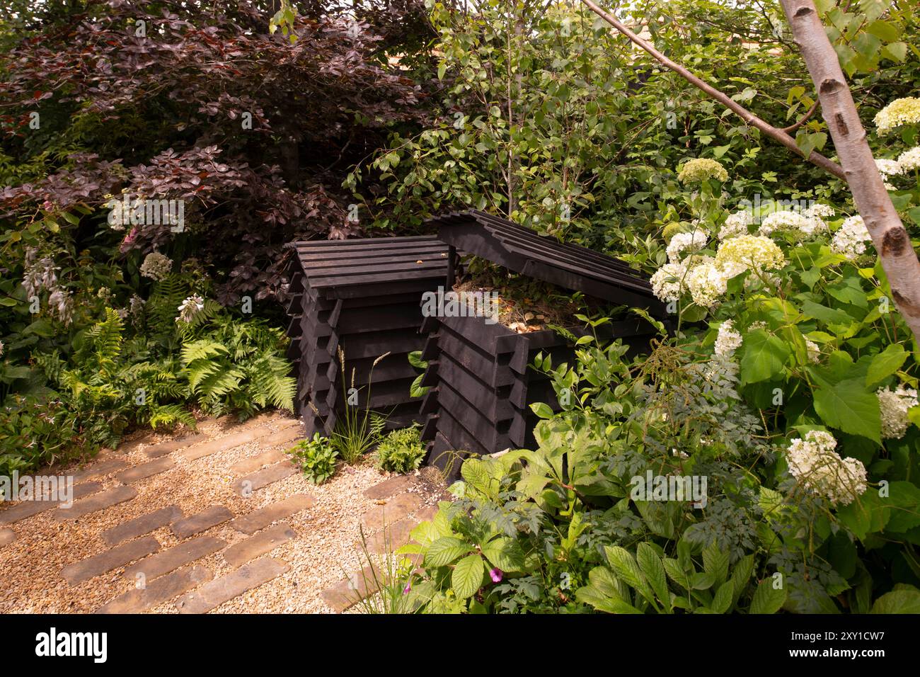 Wooden compost bins surrounded by trees and Hydrangeas in the Money ...