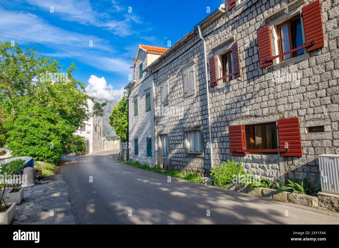 Traditional stone houses on the main street of Stoliv village, Kotor ...