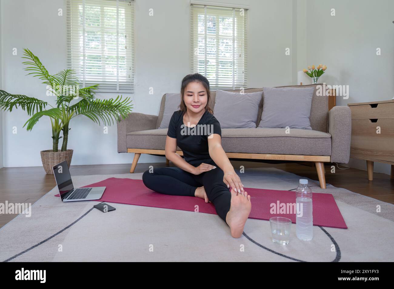 Focused Woman Practicing Stretching Exercises Indoors at Home Stock ...