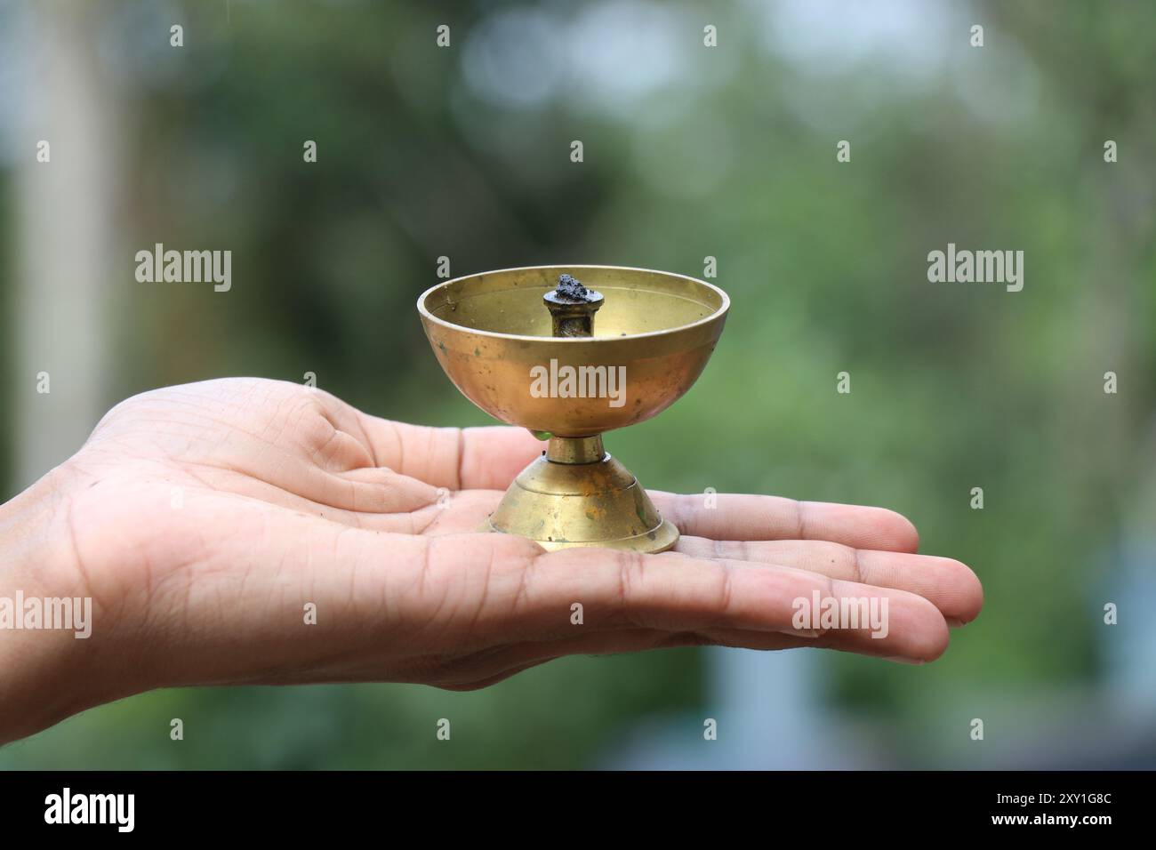 Brass diya also known as deepam used in seasonal decorations held in ...