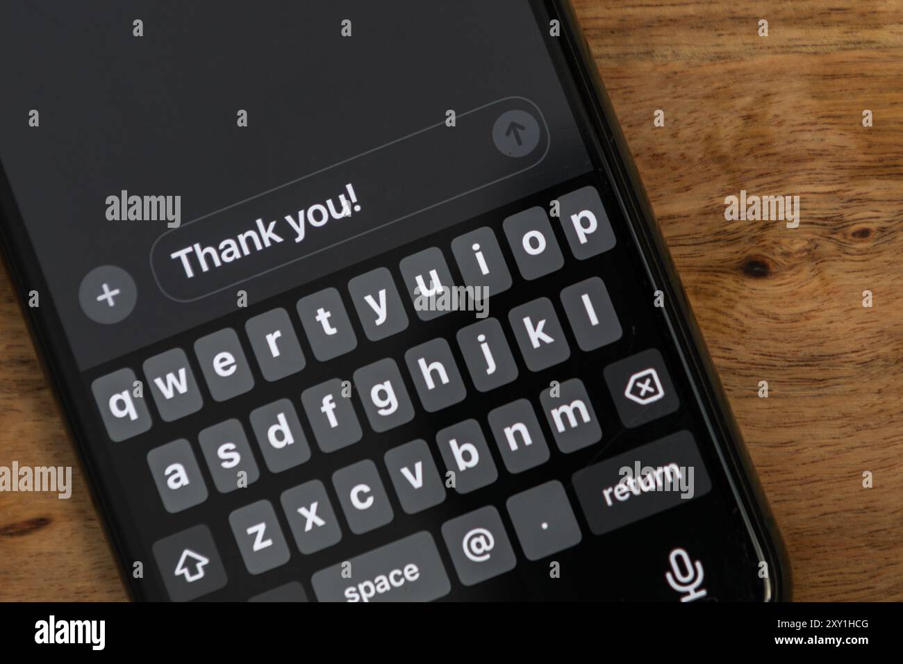 A phone with a keyboard on it that says "thank you" on it ready to send ...
