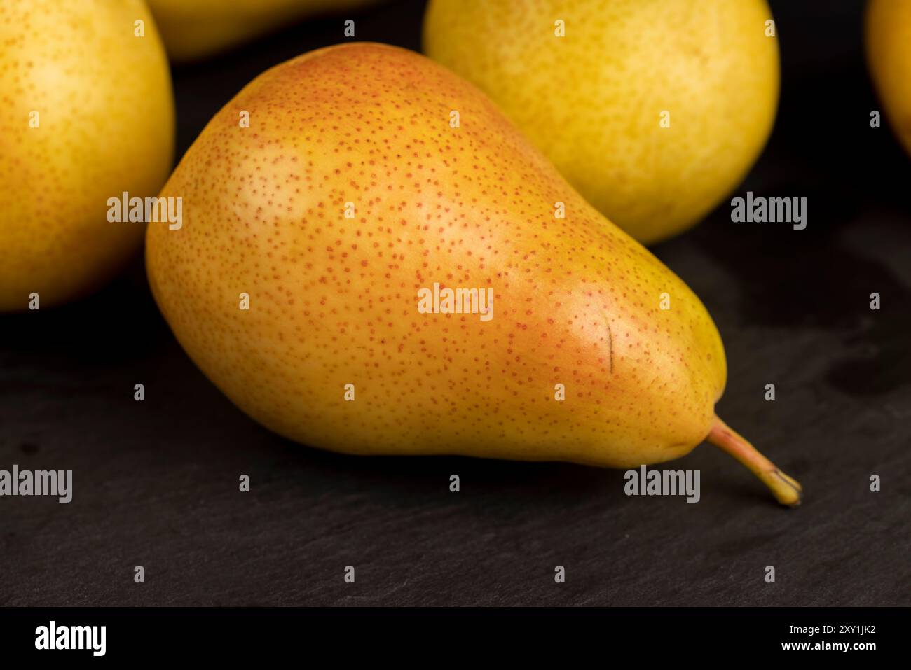 ripe yellow pears on the table, delicious yellow pears with a red side ...