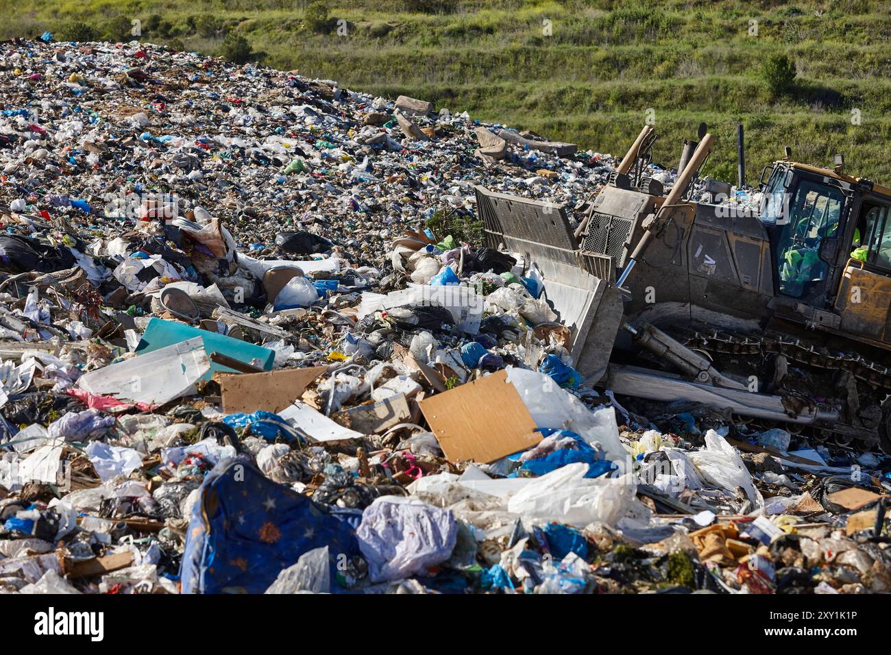 Heavy machinery shredding garbage in an open air landfill. Waste Stock ...
