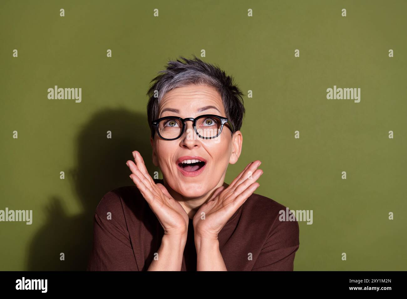 Photo of gray hair beautiful cheerful pensioner grandmother in brown t ...