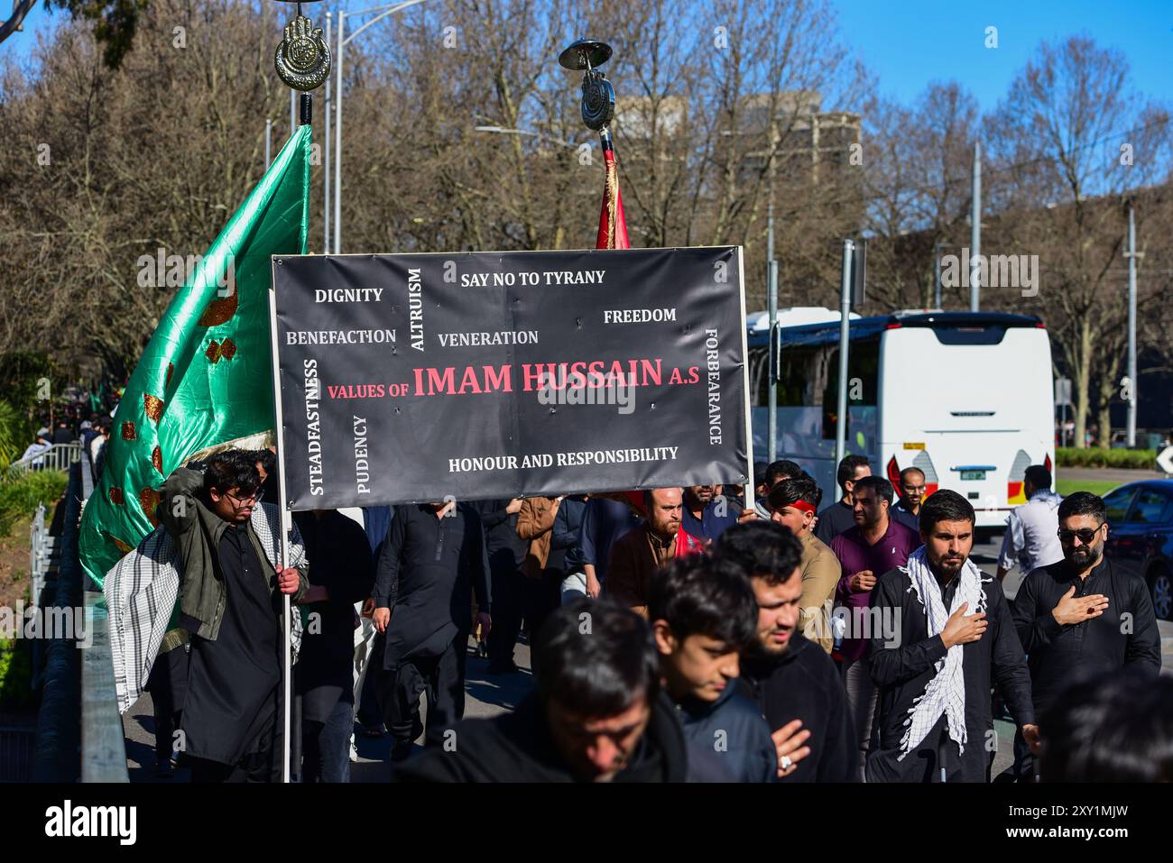 People are carrying Imam Hussain banner during Arbaeen procession. The ...