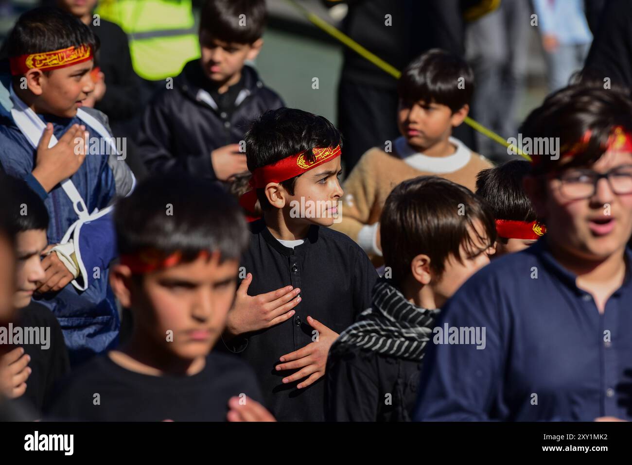 Group of boys with red Shia headbands are seen during Arbaeen ...