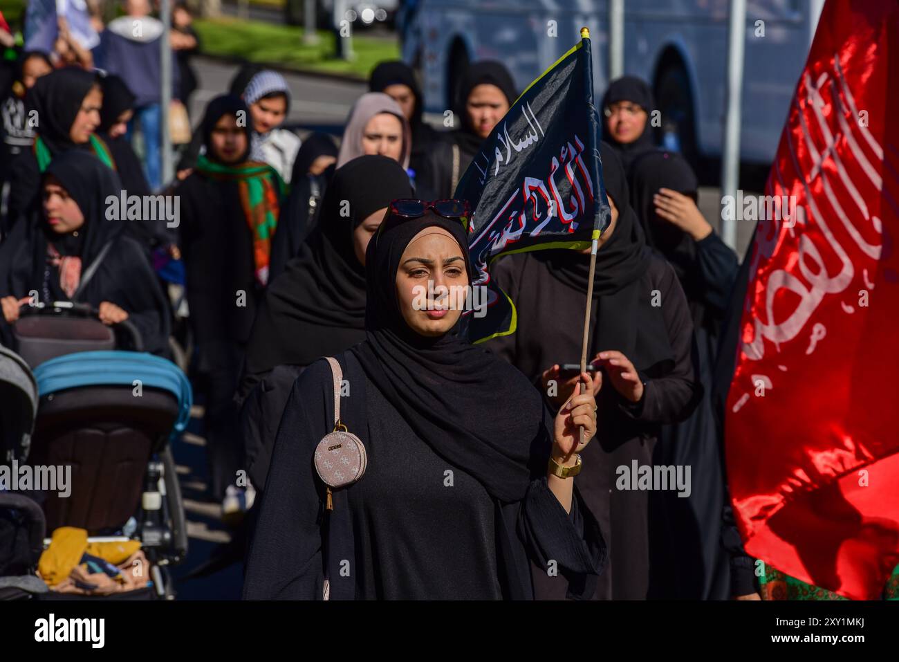 A woman with a Shia flag is seen during Arbaeen procession. The 16th ...