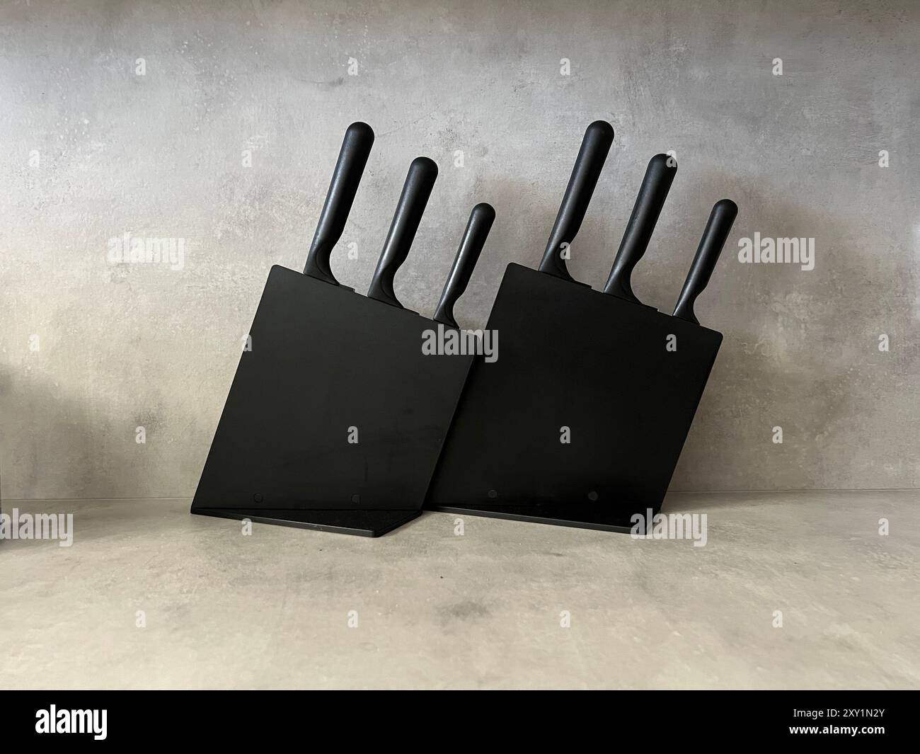 Sleek black knife set in modern magnetic blocks on a minimalist kitchen ...