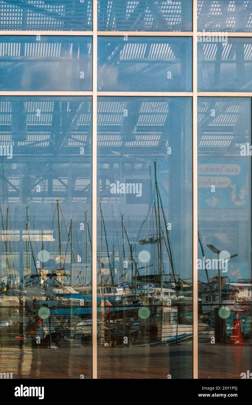 Abstract image of reflections of boats and masts in the marina's glass ...