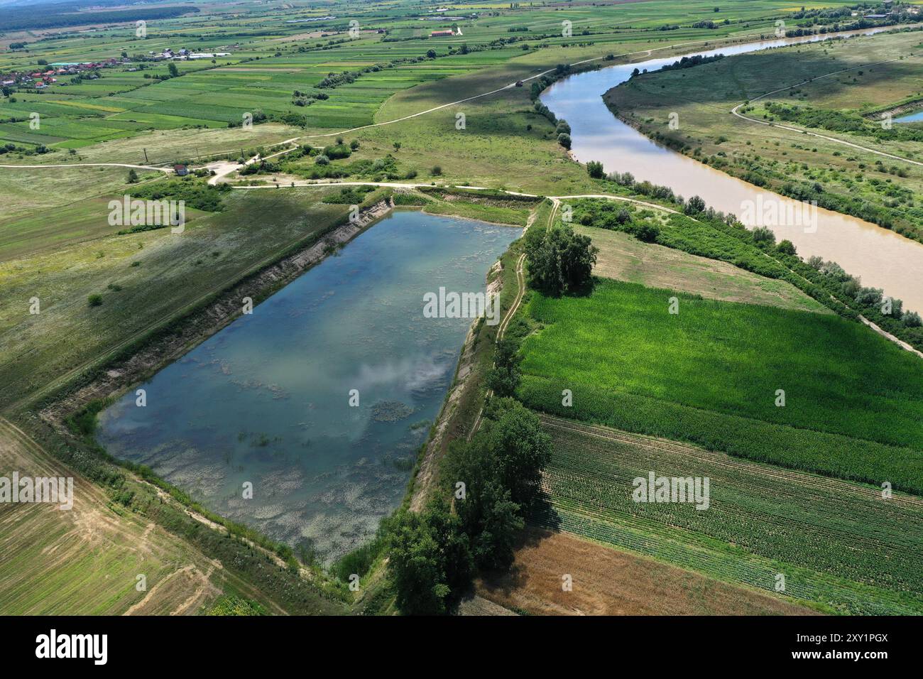 Aerial view of river gravel and sand ballast open pit mining abandoned ...