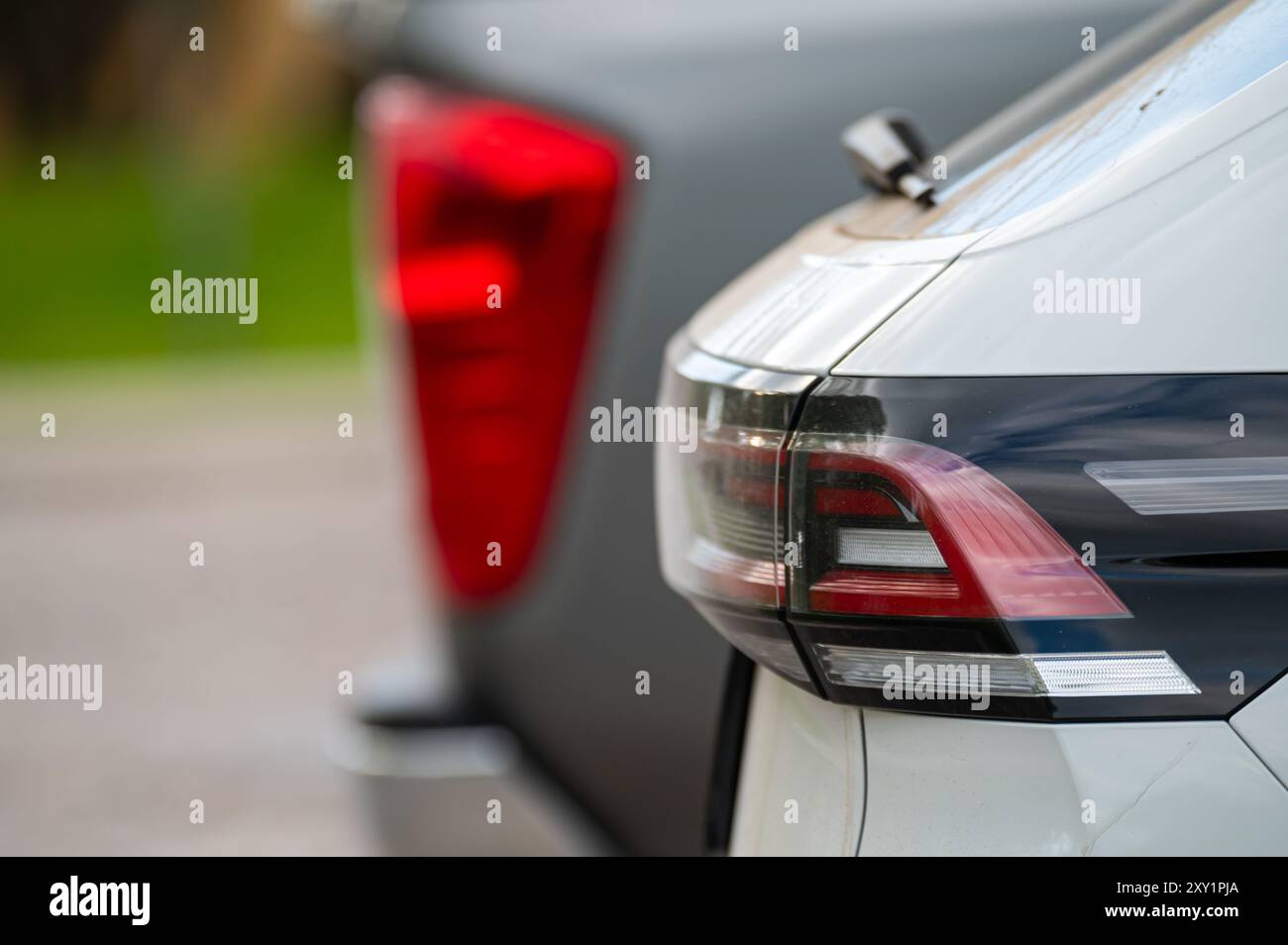 Detailed view of a cars tail lights illuminated at night. Shallow depth ...