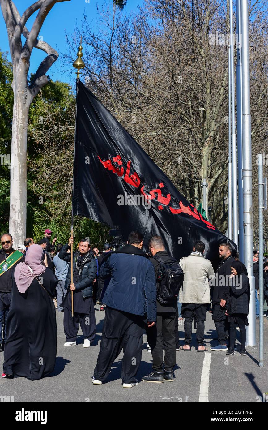 Melbourne, Australia. 25th Aug, 2024. A man holding a large islamic ...