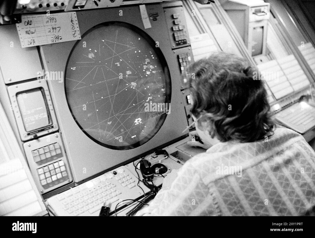 Air Traffic Controller Phil Ruskovich monitors the floating white dots ...