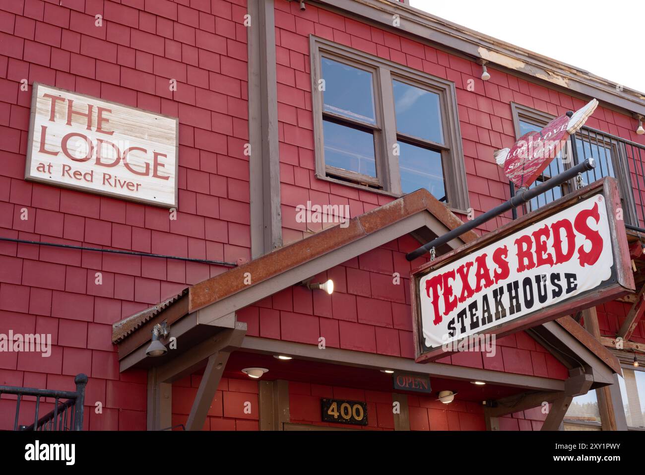 Bright red exterior of Texas Reds Steakhouse and The Lodge by Red River ...