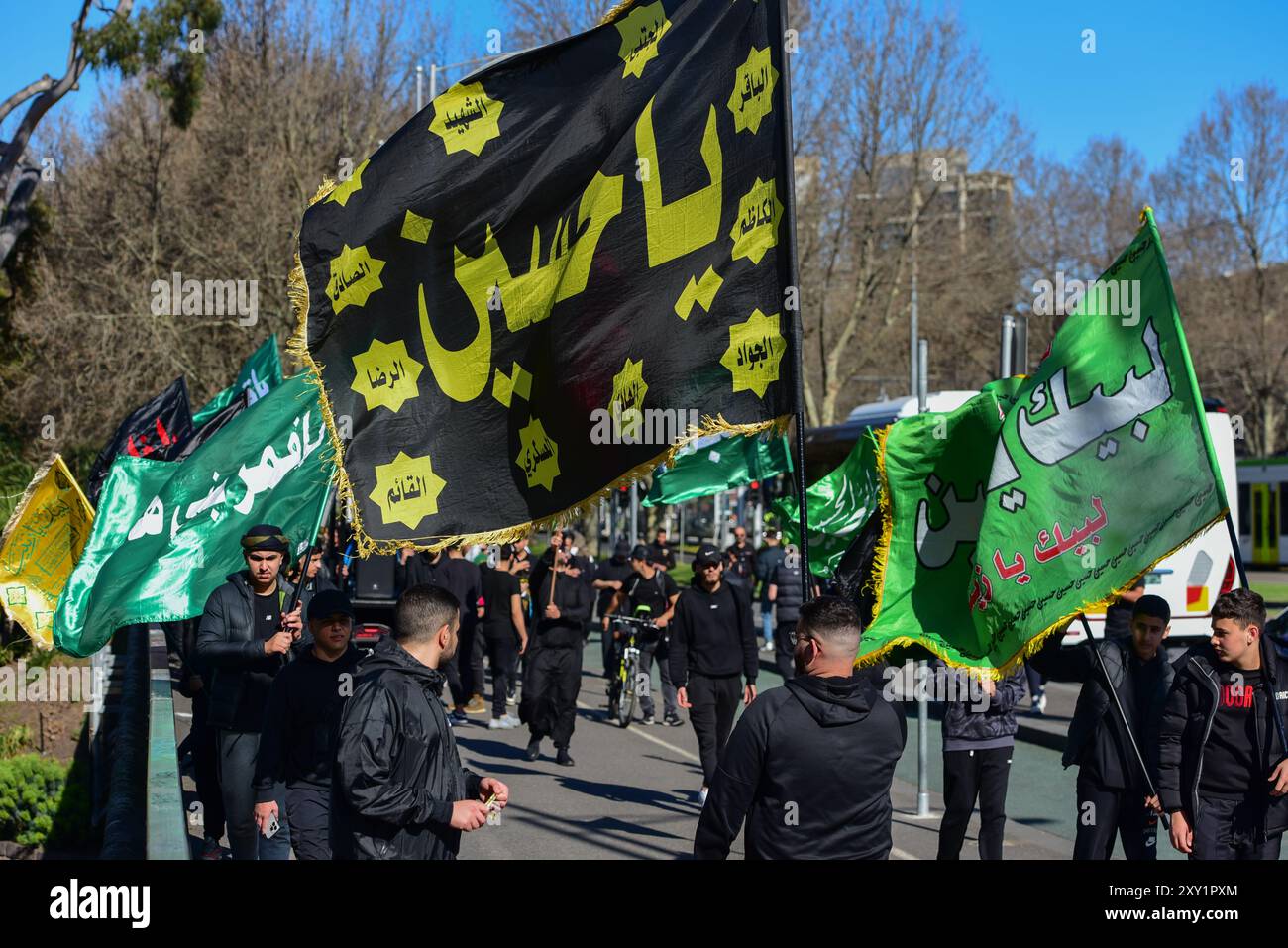 Melbourne, Australia. 25th Aug, 2024. A man holding a flag with eight ...