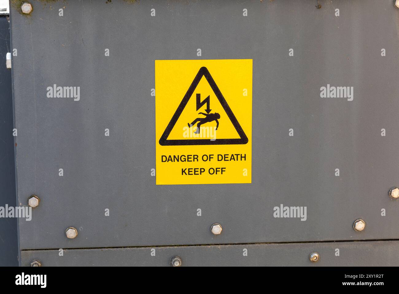 A yellow and black danger of death warning sign on an electric ...