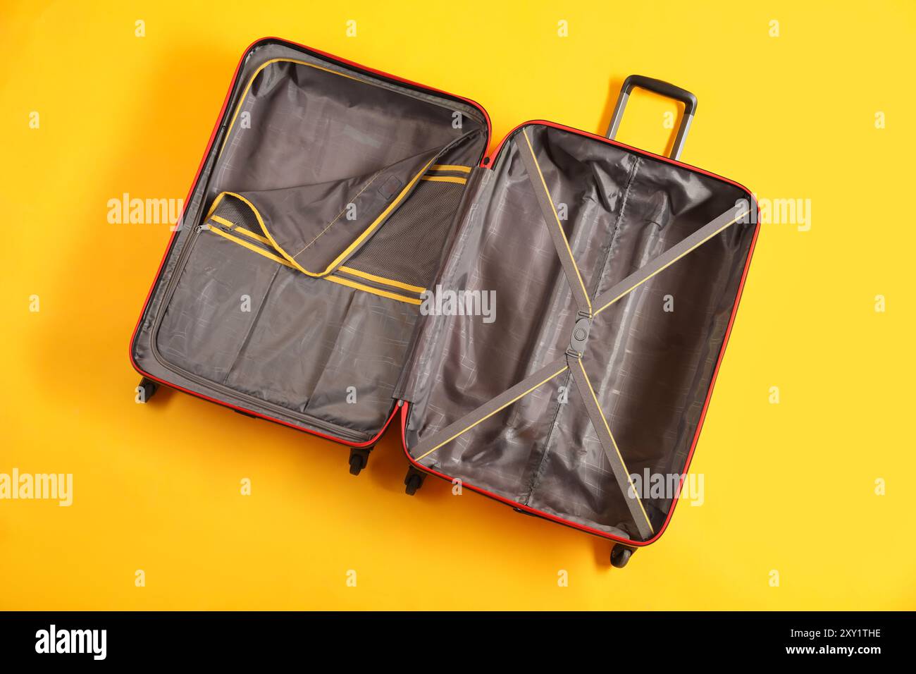Open empty suitcase for travelling on yellow background, top view Stock ...