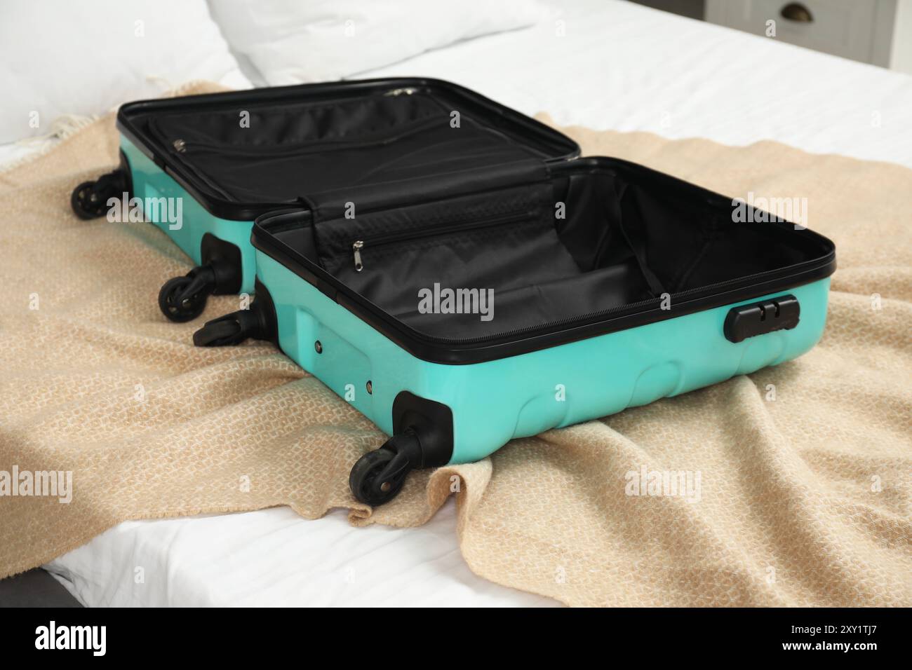 Open empty suitcase for travelling on bed indoors Stock Photo - Alamy