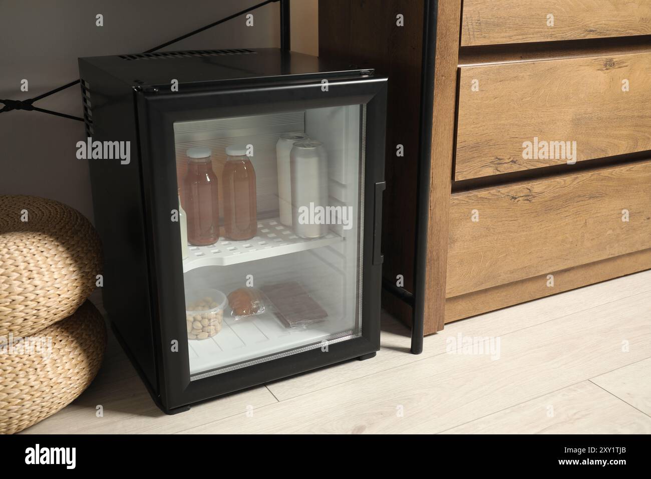 Mini refrigerator with different drinks and snacks indoors Stock Photo ...