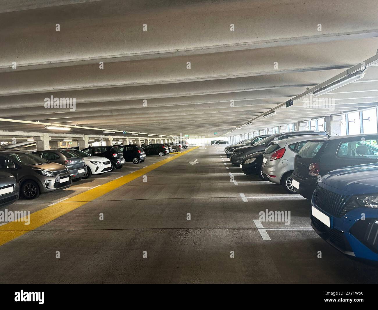 Parked cars in underground garage of apartment complex Stock Photo - Alamy