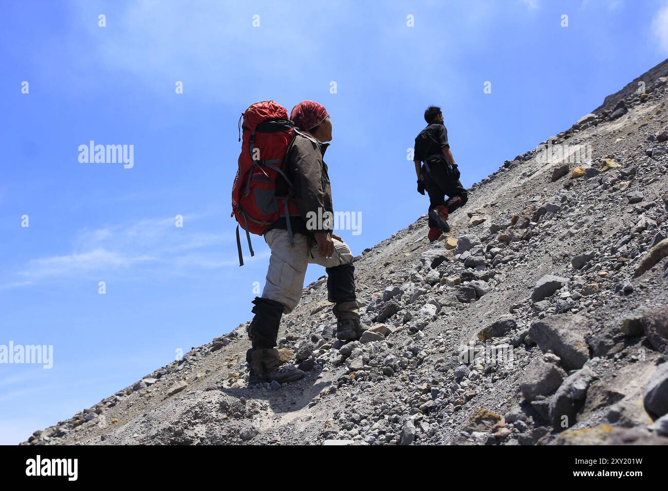 Two climbers take time off on a stretch of sand and rock on their way ...