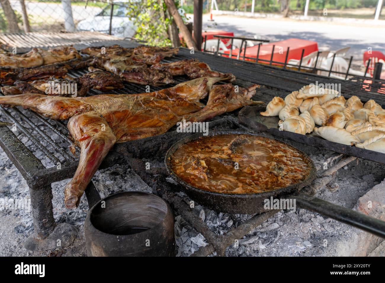 Locro, a traditional stew, & chivo or young goat cooking over the coals ...