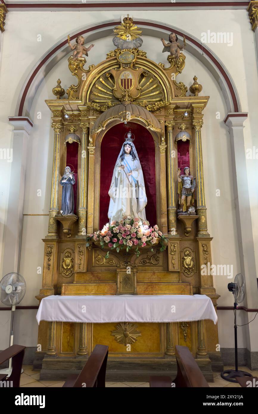 A side altar and altarpeice with a statue of the Virgin Mary in the ...