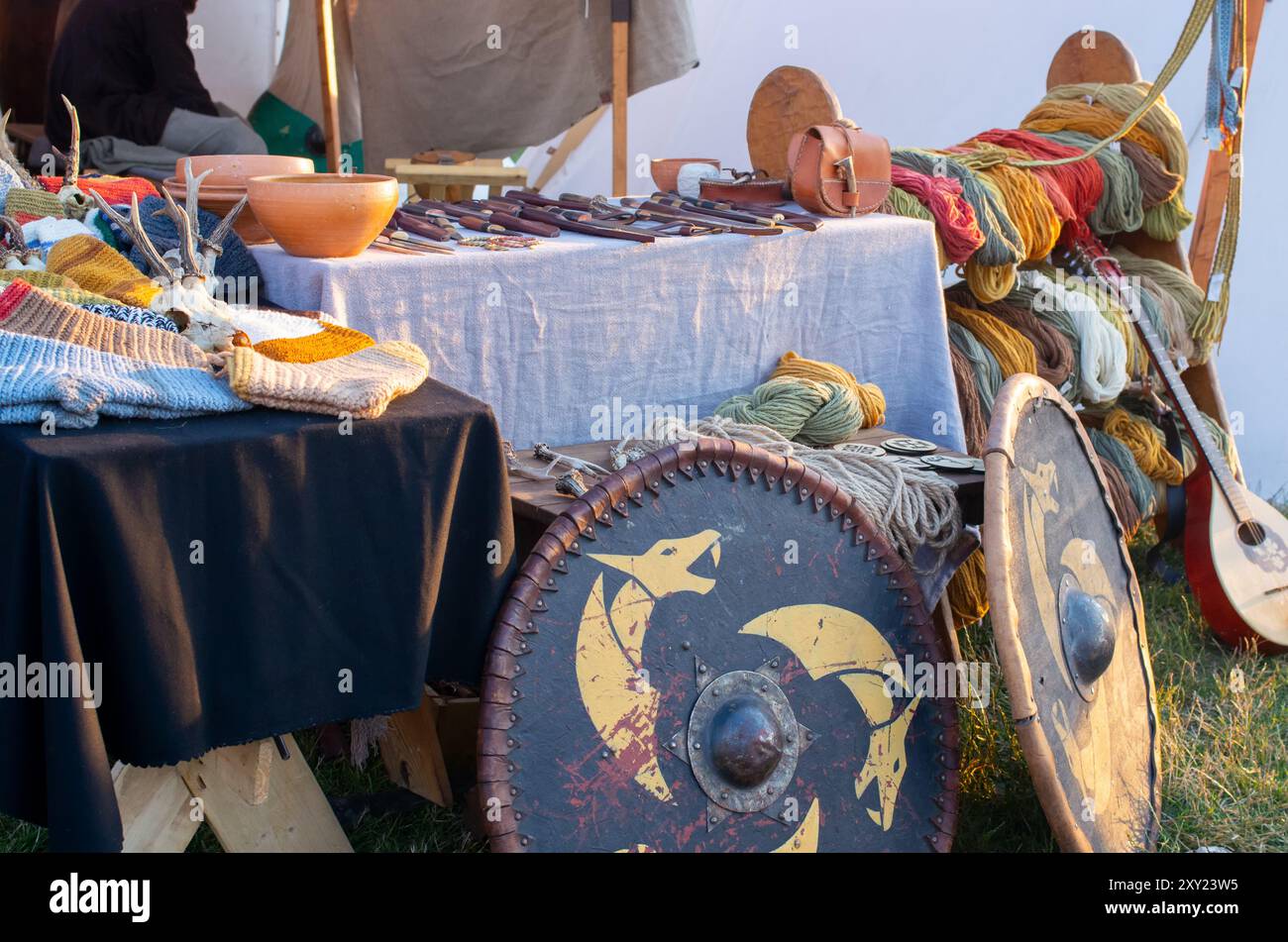 A stand with historical products at a medieval fair. Shields, musical ...