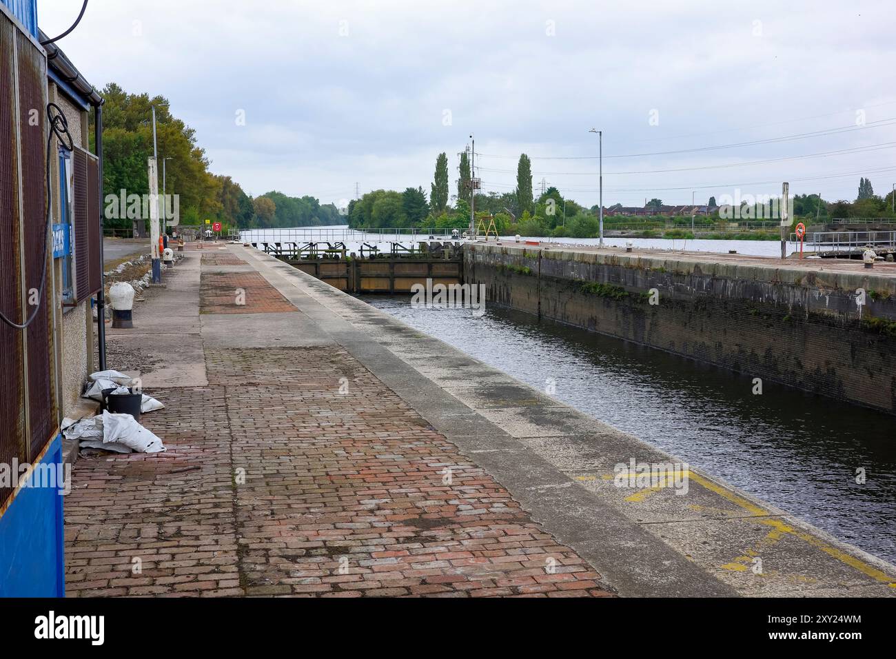 Irlam Manchester ship canal. A tranquil canal lock scene with a paved ...