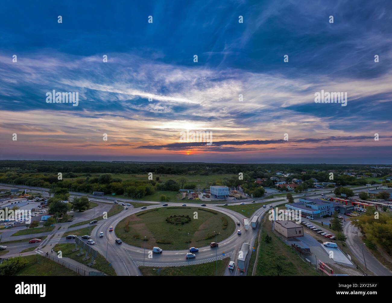 A breathtaking aerial shot of a roundabout captured at sunset, with a ...