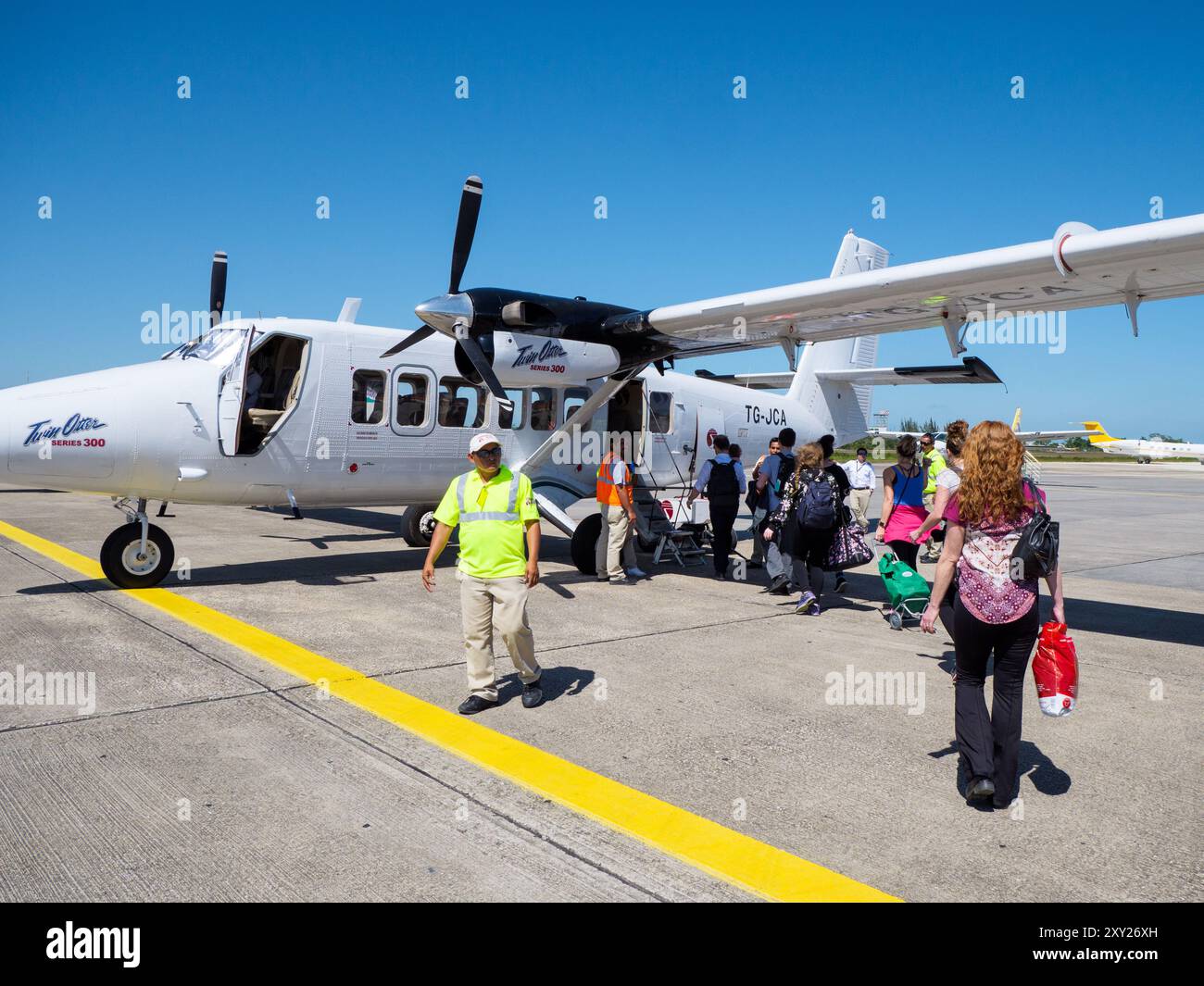 Passengers on Tarmac in Process of Boarding Connecting Flight on Puddle ...