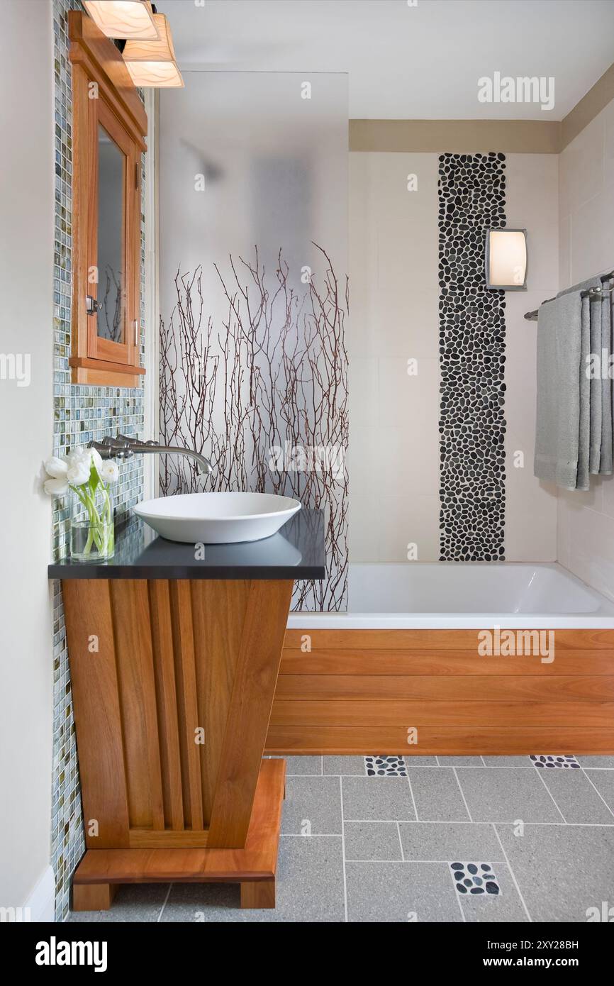 Side view of bathroom with custom vanity and blue glass tile behind ...
