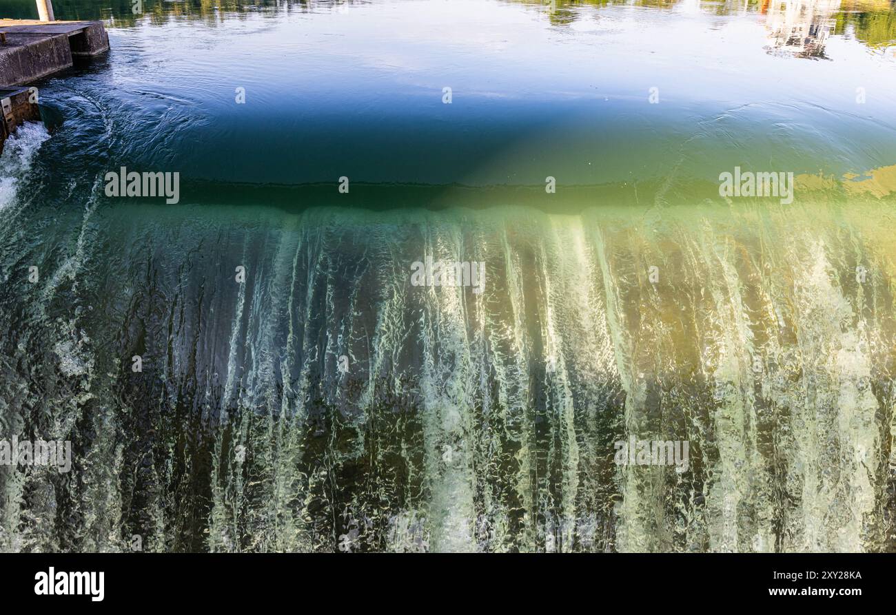 Glattfelden, Switzerland, 20th Jul 2024: The water falls over the lock ...