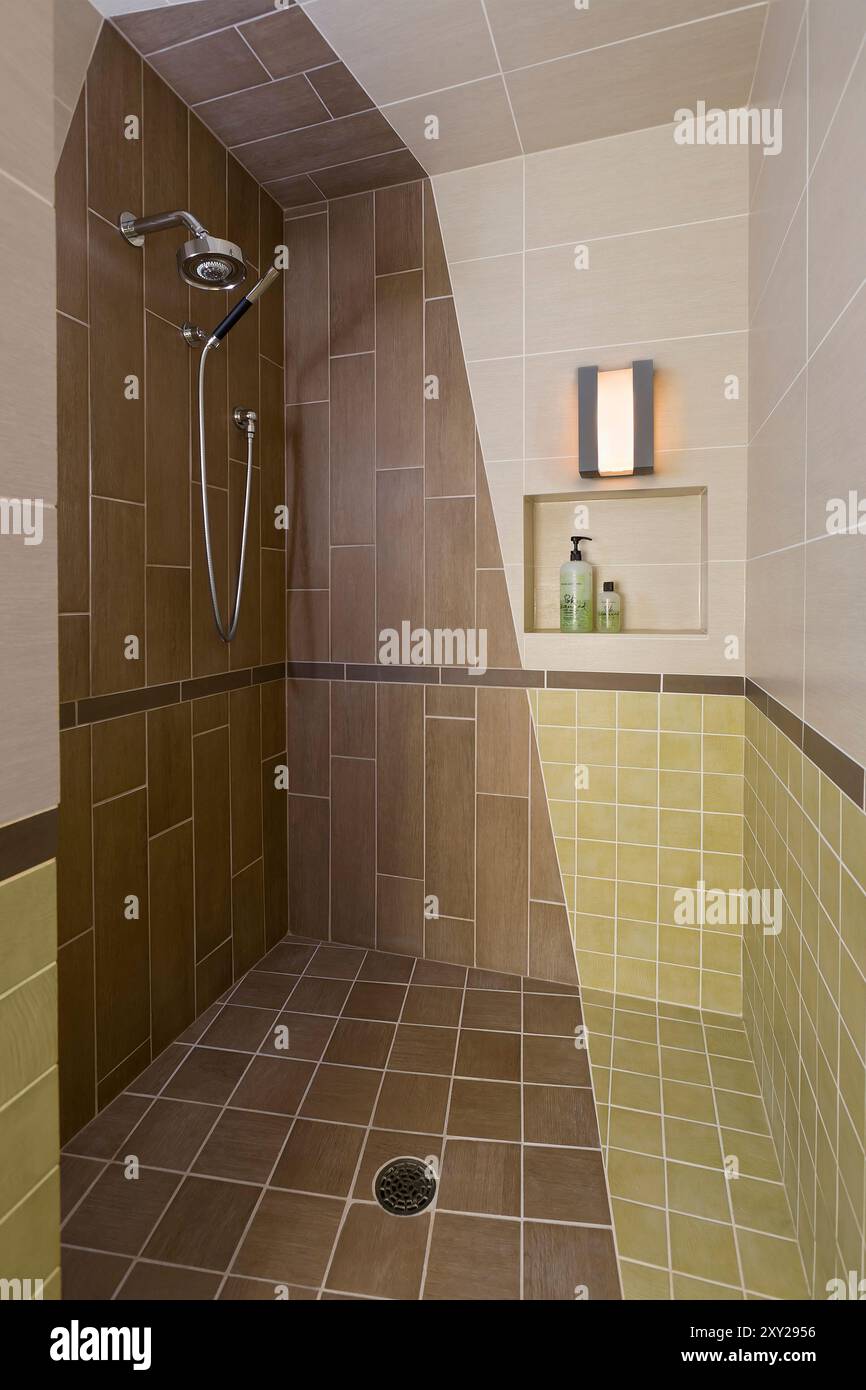 Large walk-in shower with modern dynamic design of wall and floor tile ...