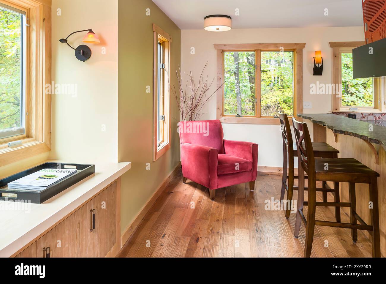 Red velvet armchair sits in corner of large kitchen with sitting area ...