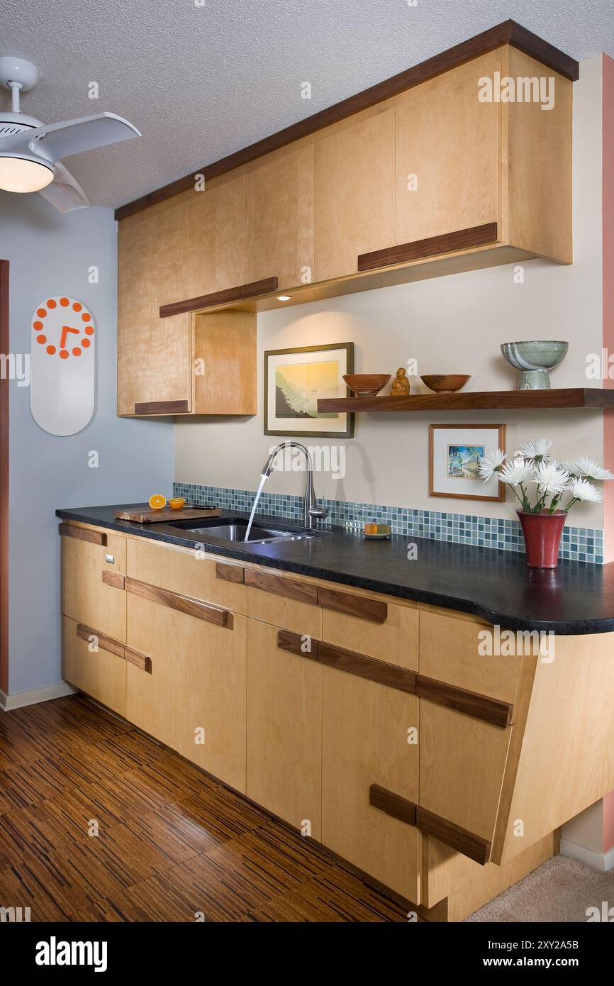 One wall of small galley kitchen with interesting Asian accents Stock ...