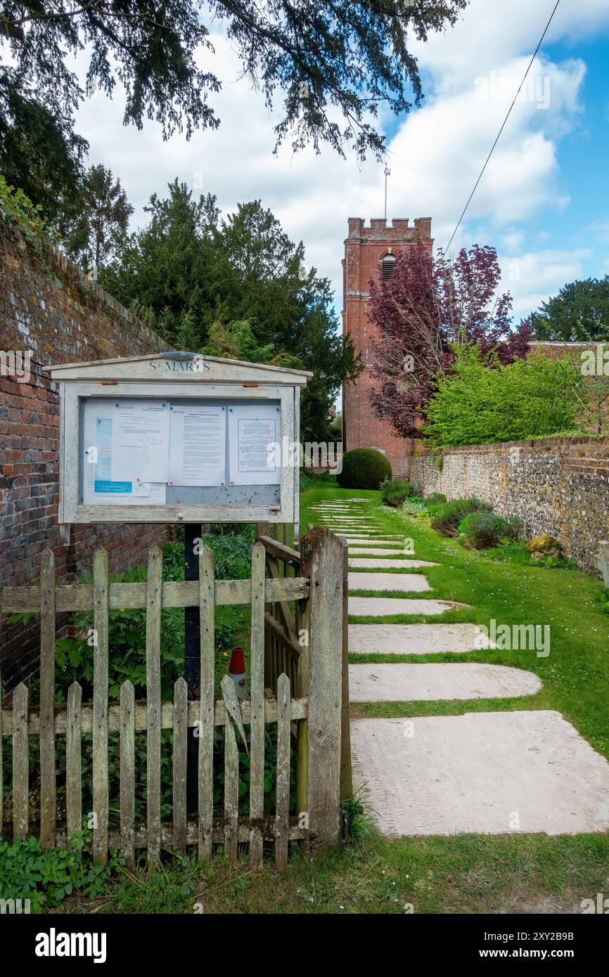 The picturesque Church of St Mary in Avington with its rustic red brick exterior and lush green ...