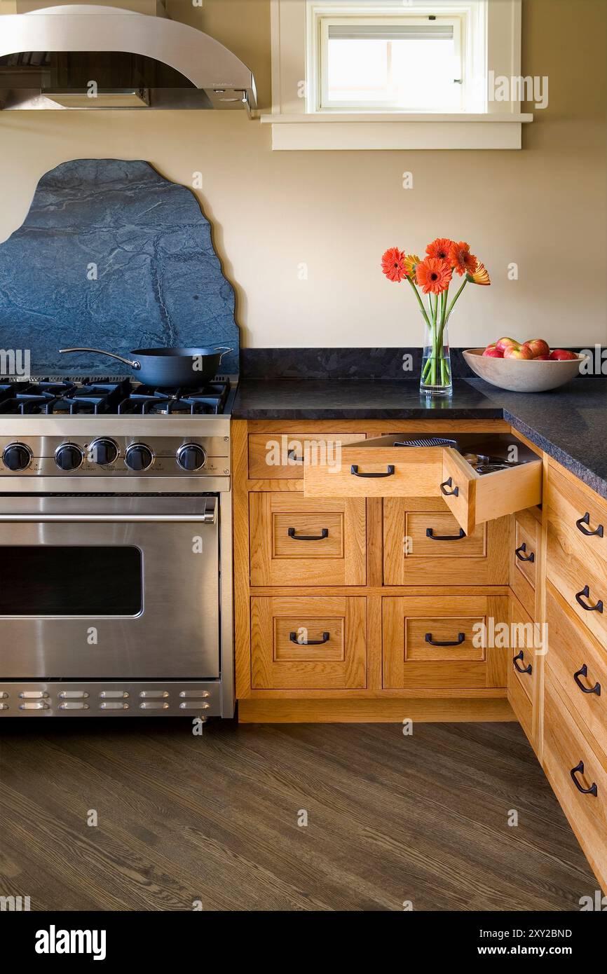 Corner of kitchen showing cabinets with one corner drawer open Stock ...