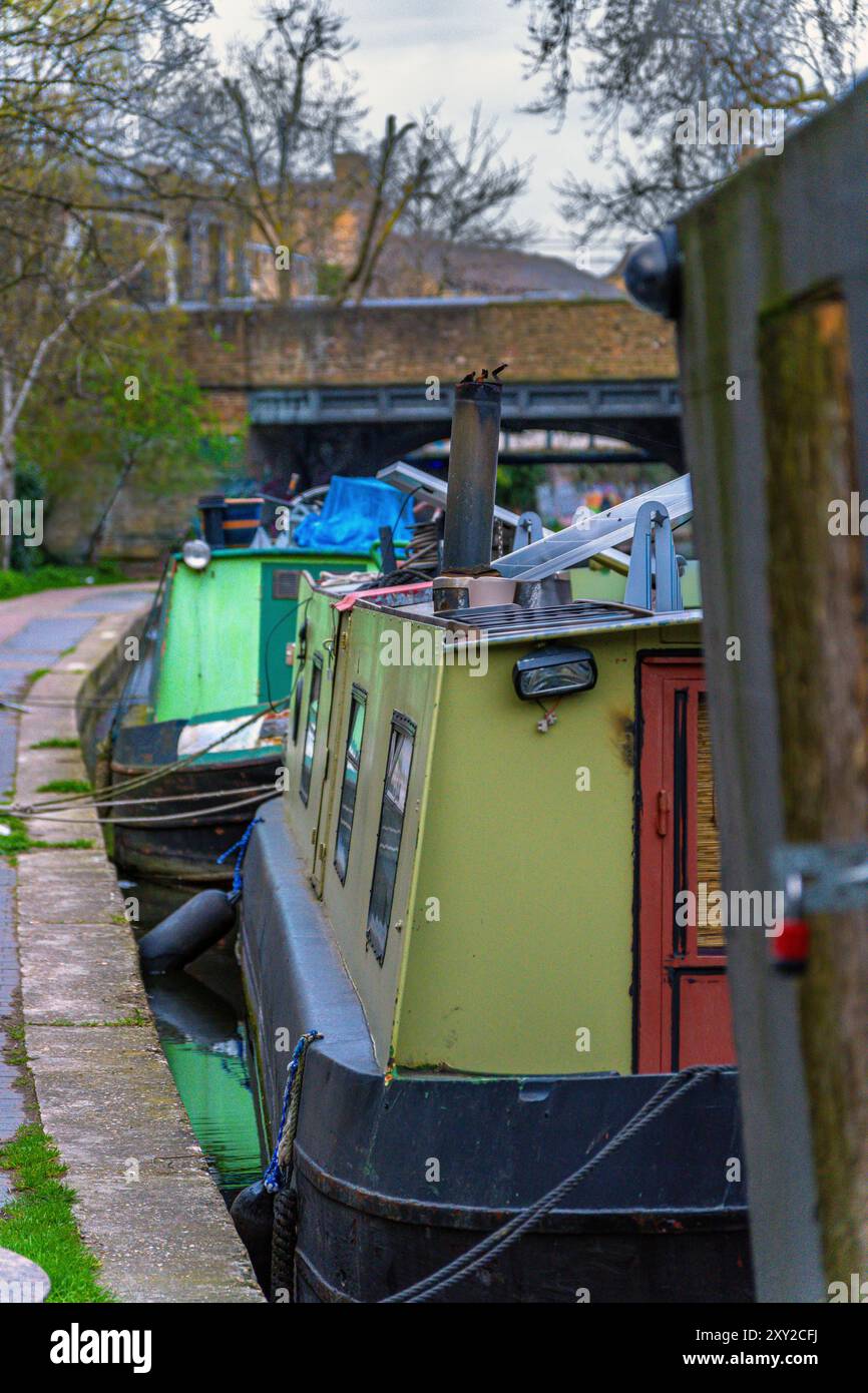 Colorful narrowboats and narrow houseboats docked and moored on the ...