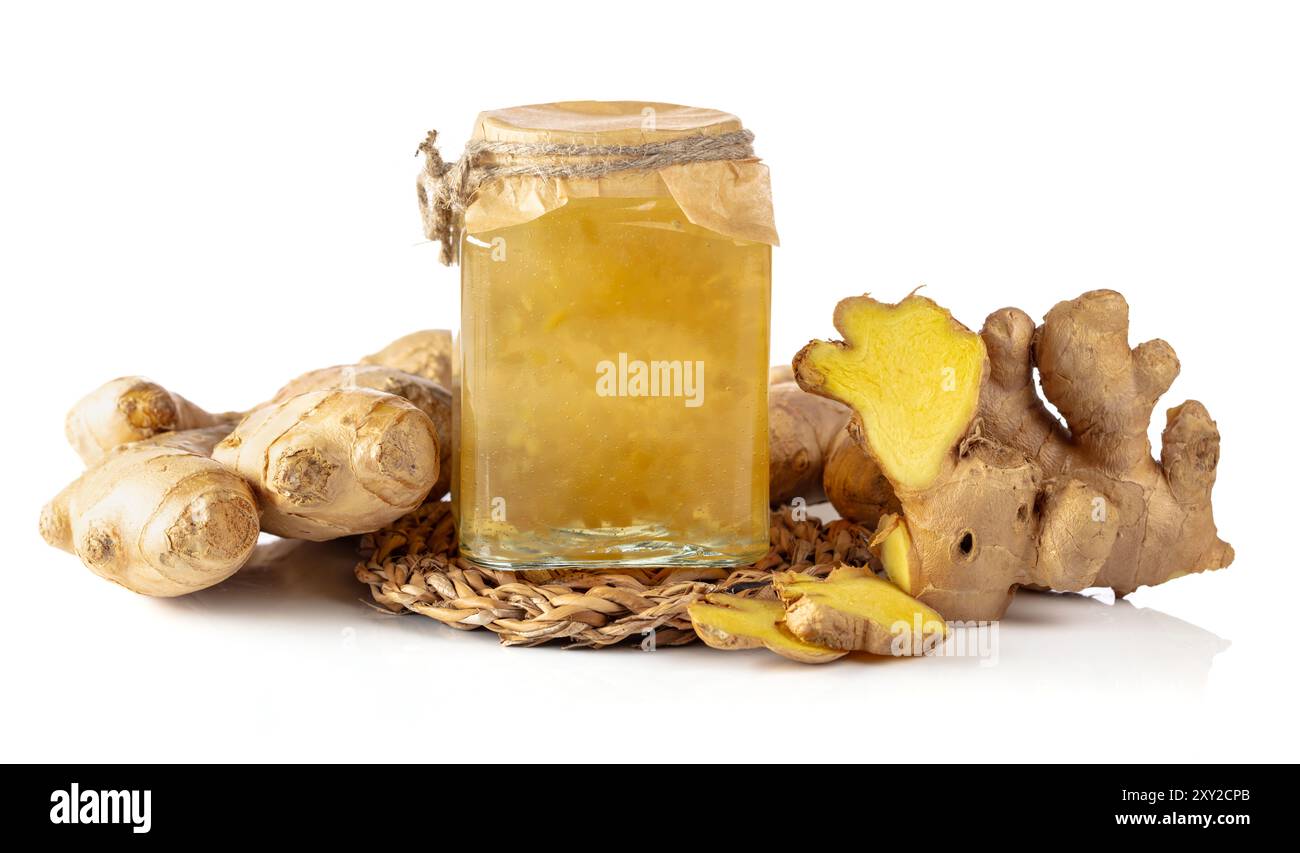 Ginger jam in small square jar and fresh ginger isolated on a white ...