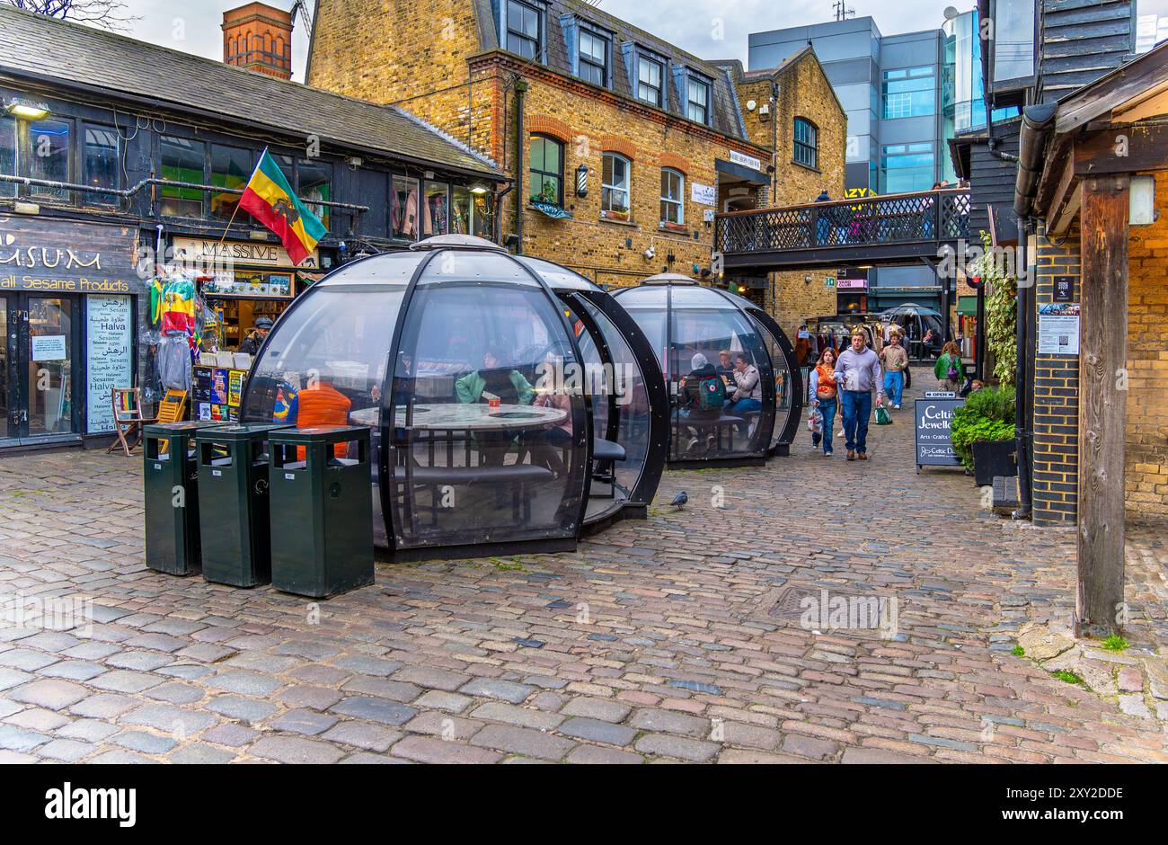 People and friends drinking coffee and beers in dining pods inside ...