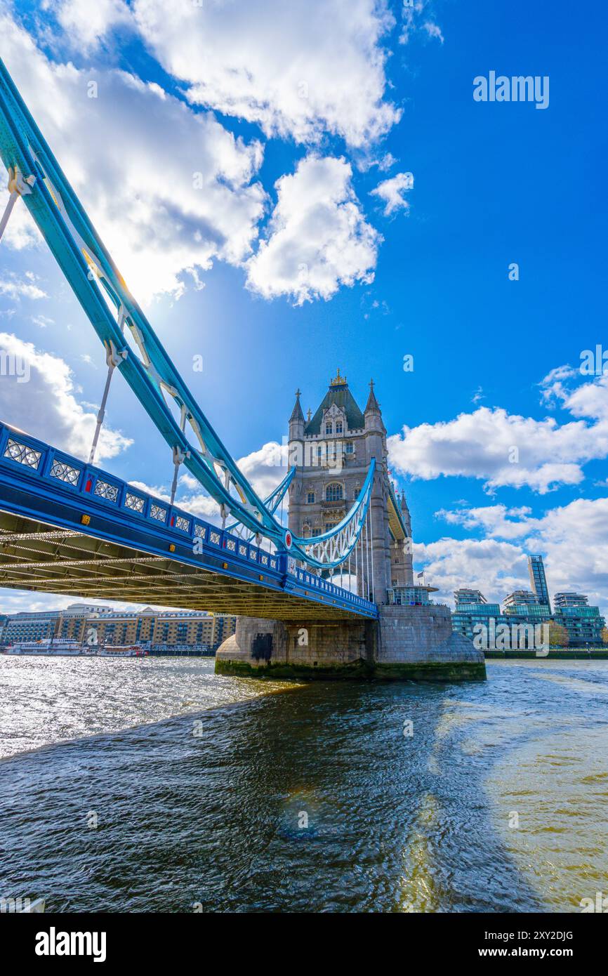 Diagonal view from below of London's Tower Bridge casting its shadow on ...