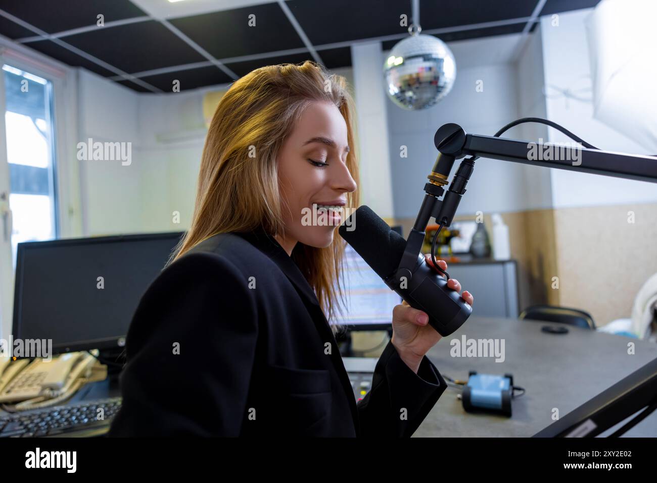 Woman singing at radio station live host Stock Photo - Alamy