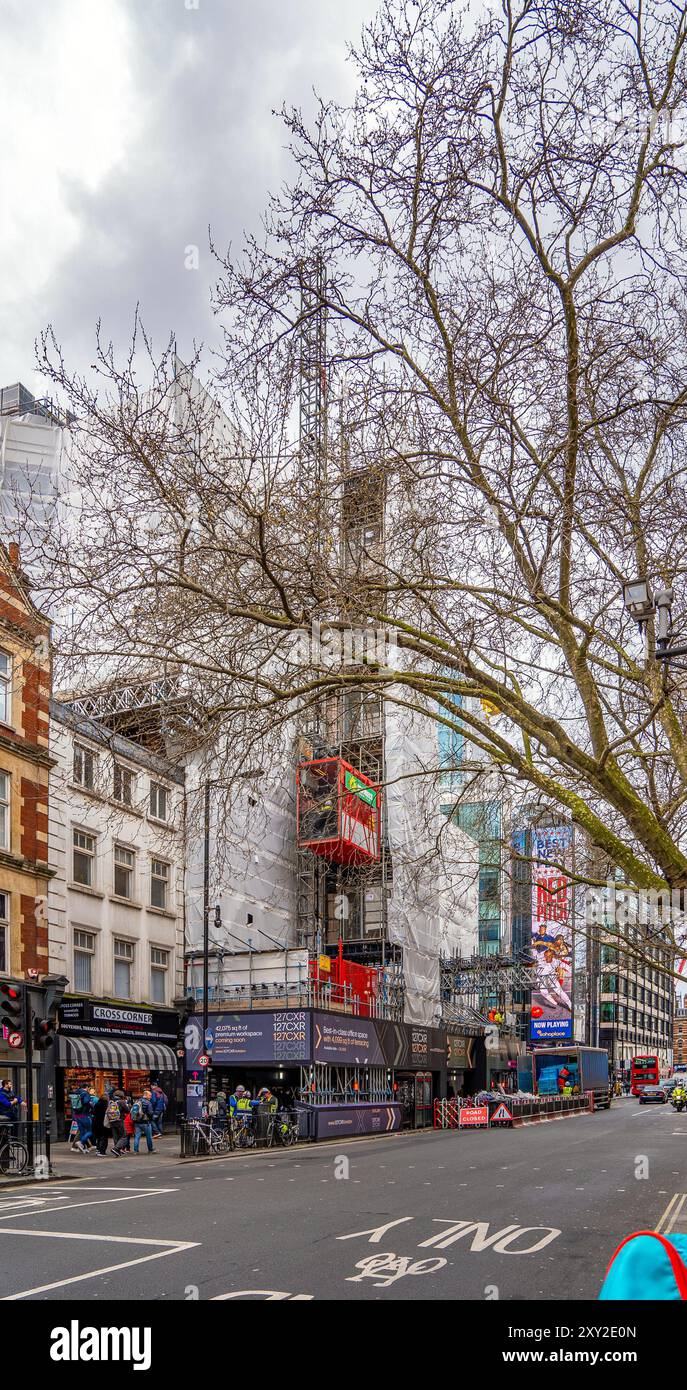 Street in central London with a building under construction with a red ...