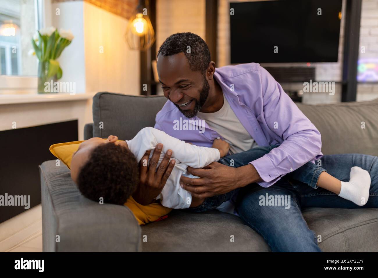 Dad hugging his son and looking happy and enjoyed Stock Photo - Alamy