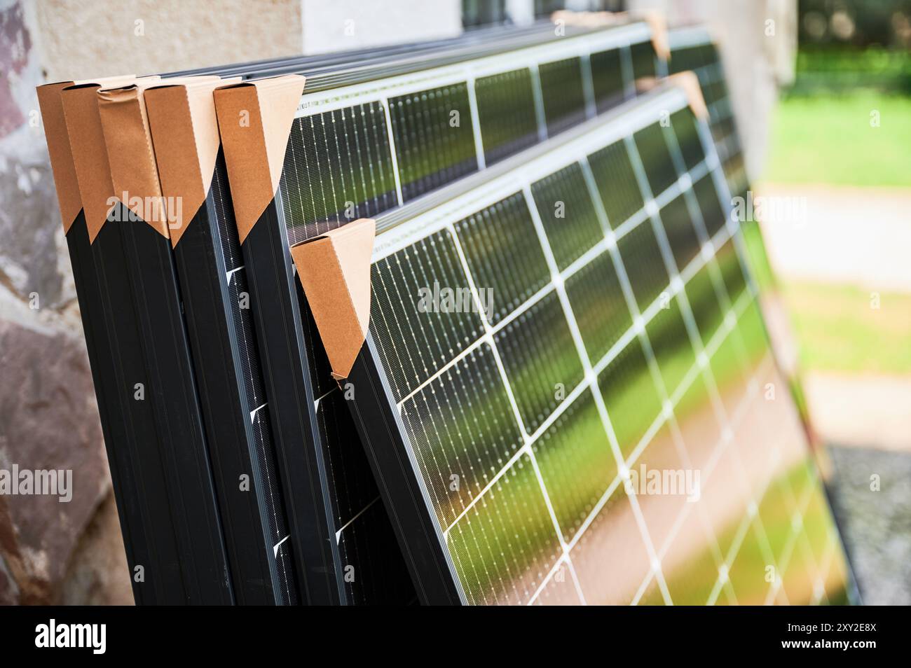 Close-up new solar panels with protective cardboard corners, ready for ...