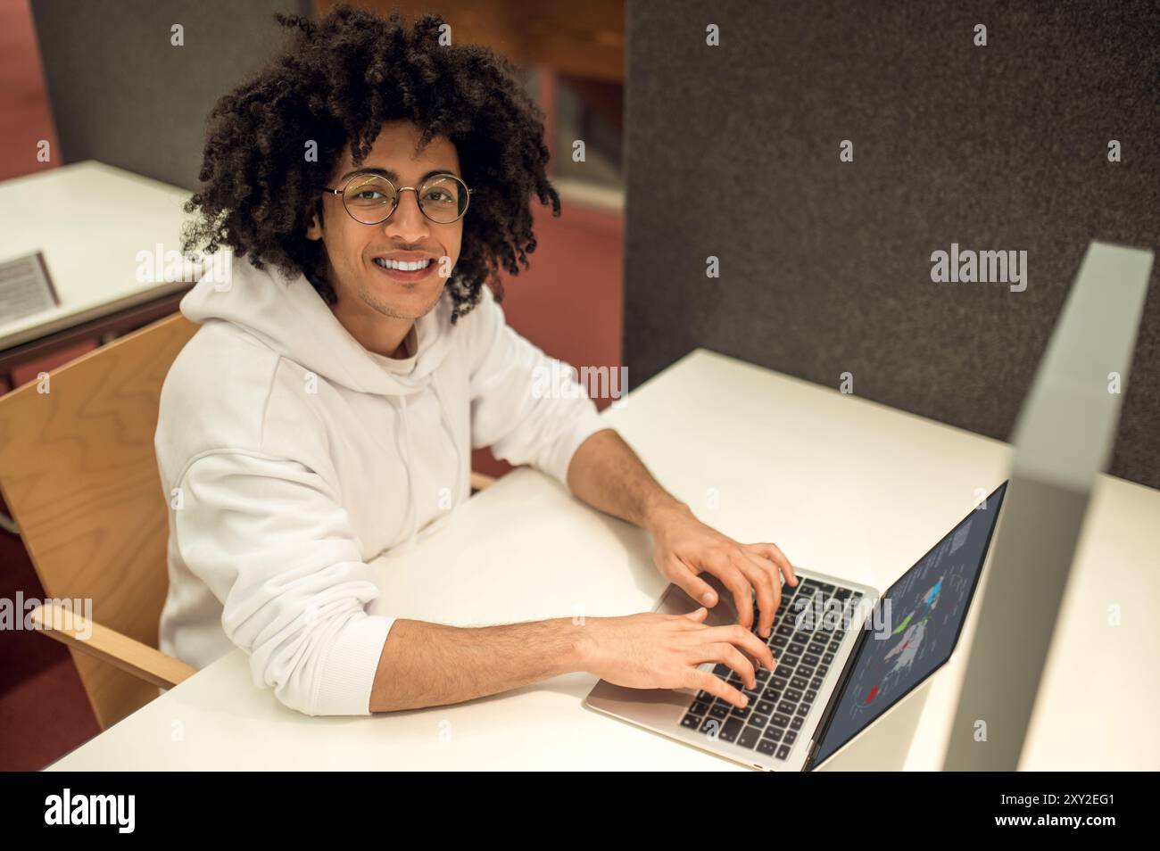 Man studying with computer preparing for exams in high school library ...