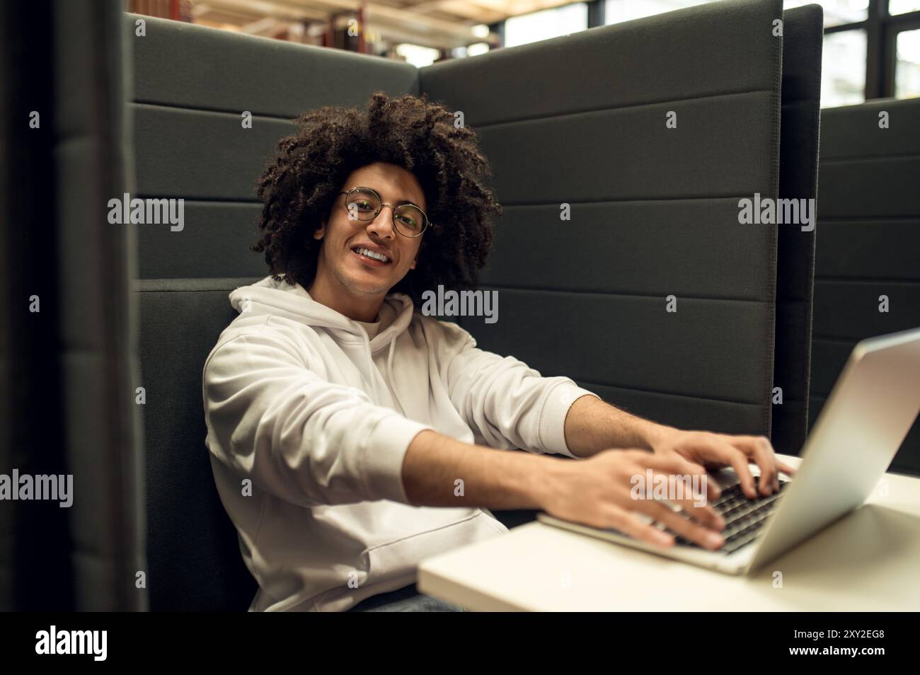 Man studying with computer preparing for exams in high school library ...