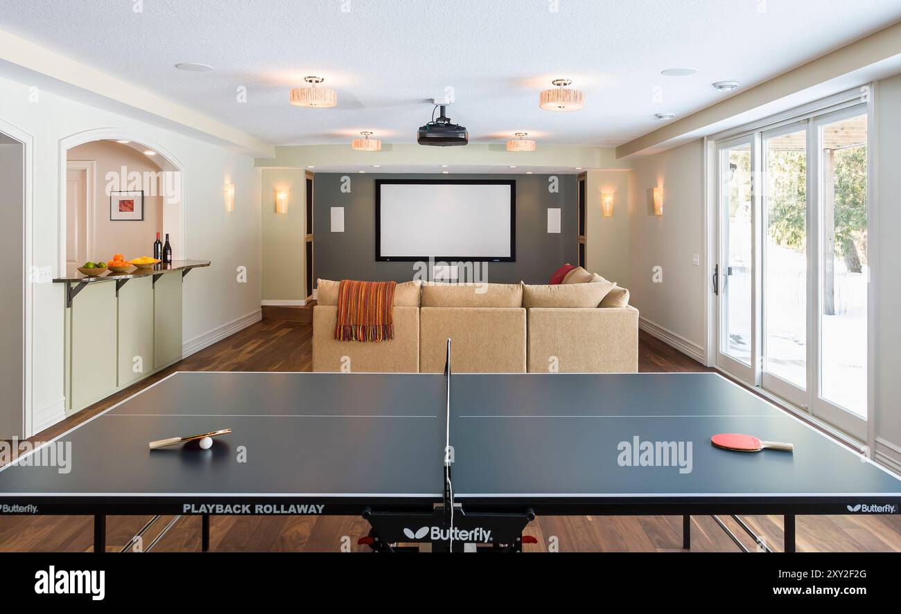 Basement family room with ping pong table and screening room Stock ...